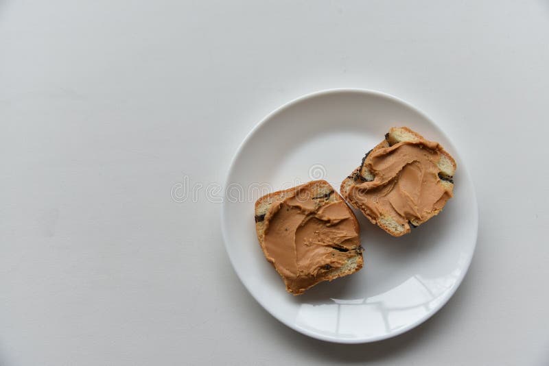 Nut Paste Spread on a Piece of Bread on a Plate Stock Image - Image of ...