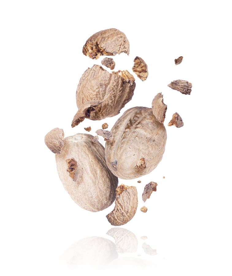 Nutmeg Crushed into Pieces Frozen in the Air, Isolated on a White ...