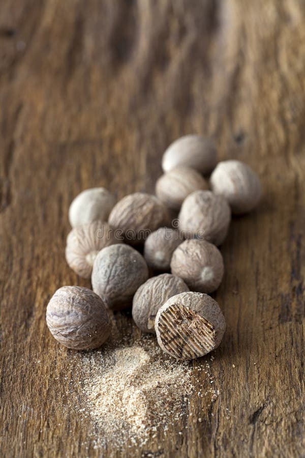 Nutmegs on wooden plate stock photo. Image of macro, spice - 31015832