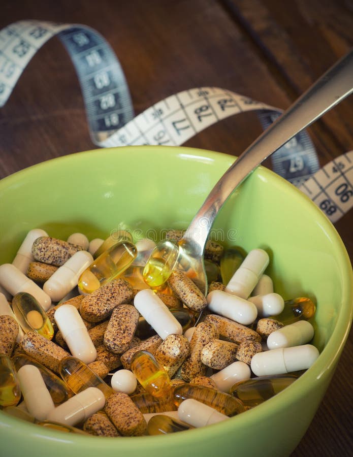 Nutritional Supplements in Capsules and Tablets, on Wooden Background ...