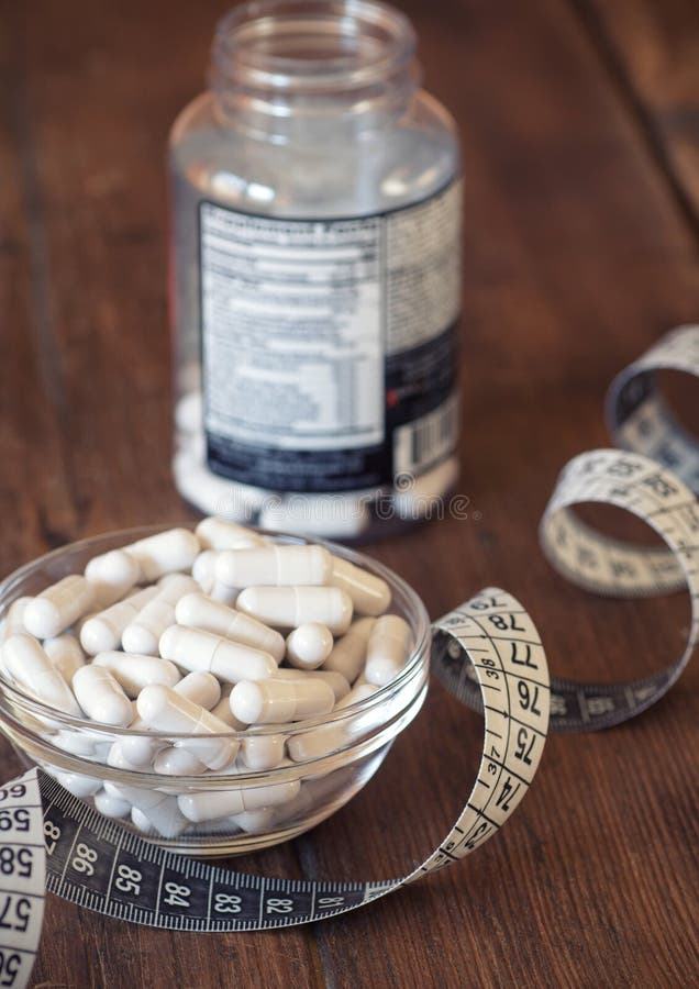 Nutritional Supplements in Capsules and Tablets, on Wooden Background ...