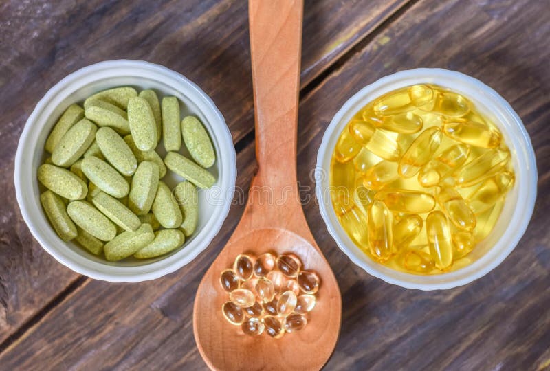 Various Dietary Supplements on Wooden Background Stock Photo - Image of ...