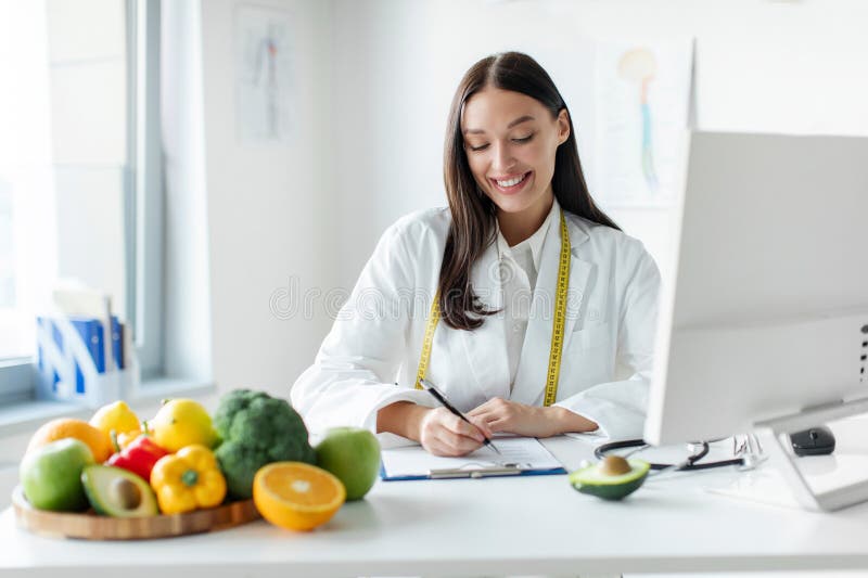 Nutritionist Woman Working in Office, Writing Diet Plan on Table and ...