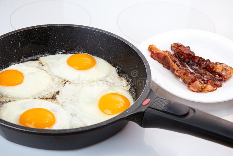 A Nutritious Breakfast of Fried Eggs and Crispy Bacon. the Process of ...