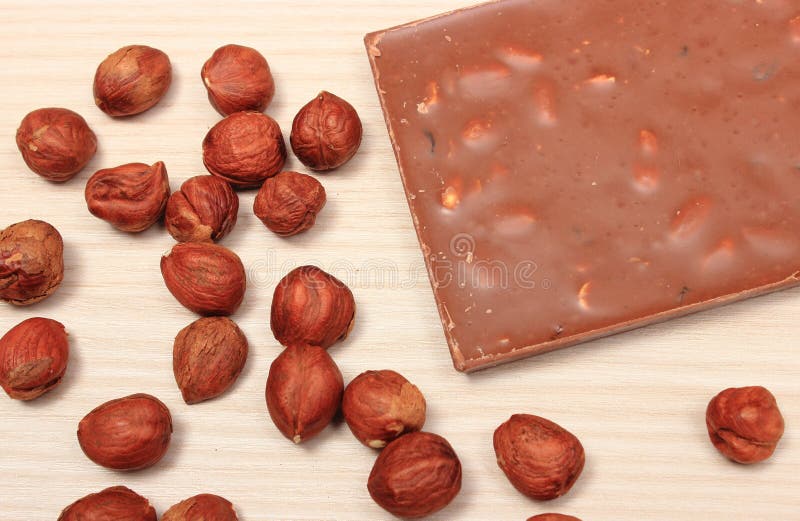 Nutritious Chocolate and Hazelnuts on Wooden Table Stock Photo - Image ...