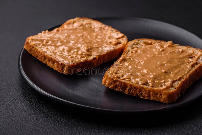 Nutritious Sandwich Consisting of Bread and Peanut Butter on a Black ...