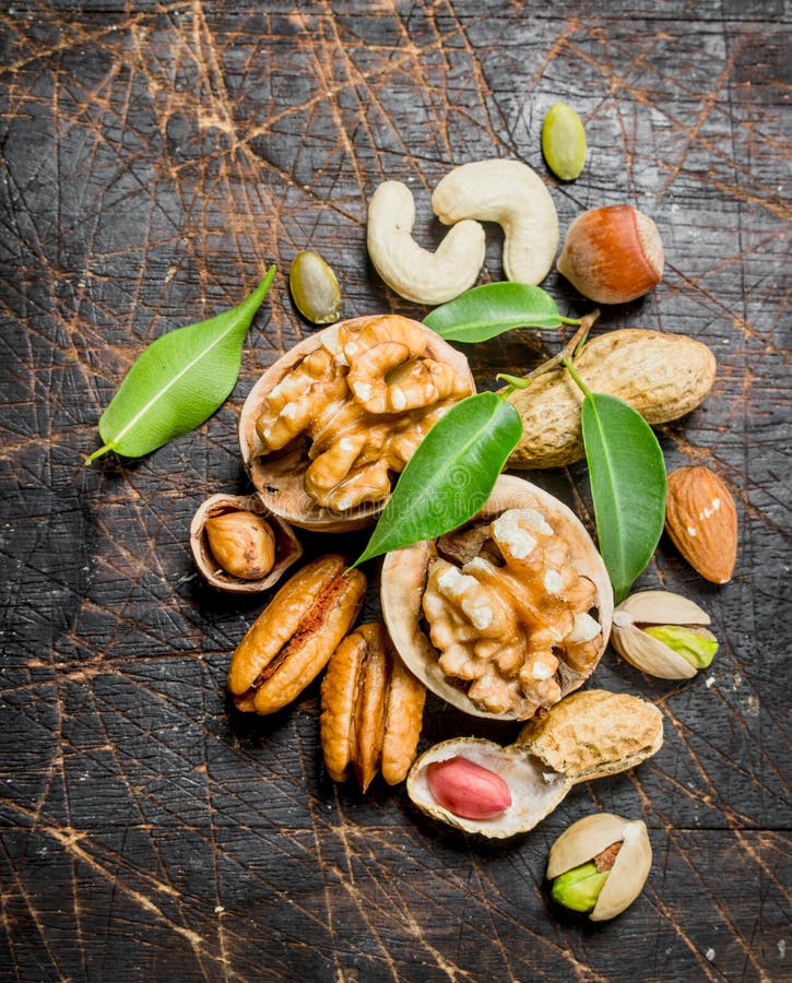Nuts Background. Assortment of Different Nuts with Green Leaves Stock ...