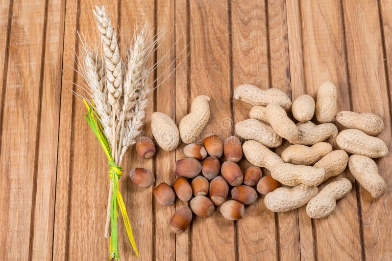 Nuts with Wheat Ears on Wooden Table. Stock Image - Image of organic ...