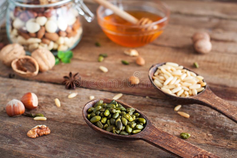 Nuts on wooden table stock photo. Image of assortment - 75747550