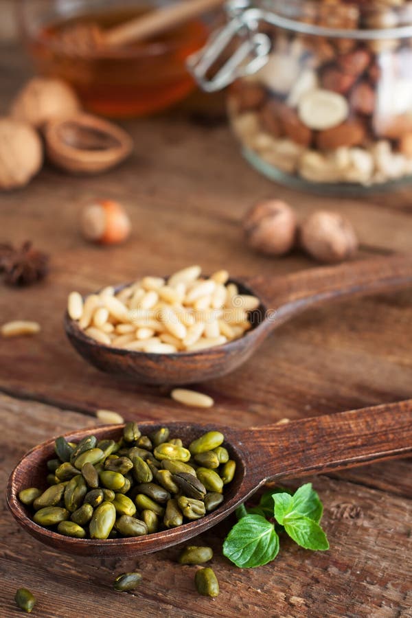 Nuts on wooden table stock photo. Image of organic, natural - 75419880