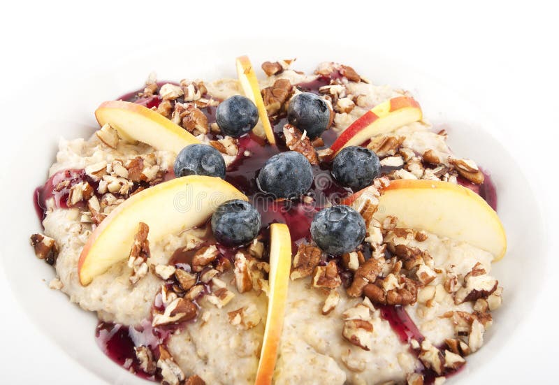 Oatmeal with Apples, Black Berries, Nuts and Topping Stock Image ...