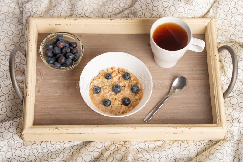 Oatmeal with Berries on a Tray in Bed with Tea, Morning Breakfast and ...