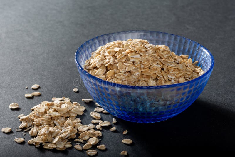 Oatmeal in a Blue Cup on a Black Background. Stock Image - Image of ...