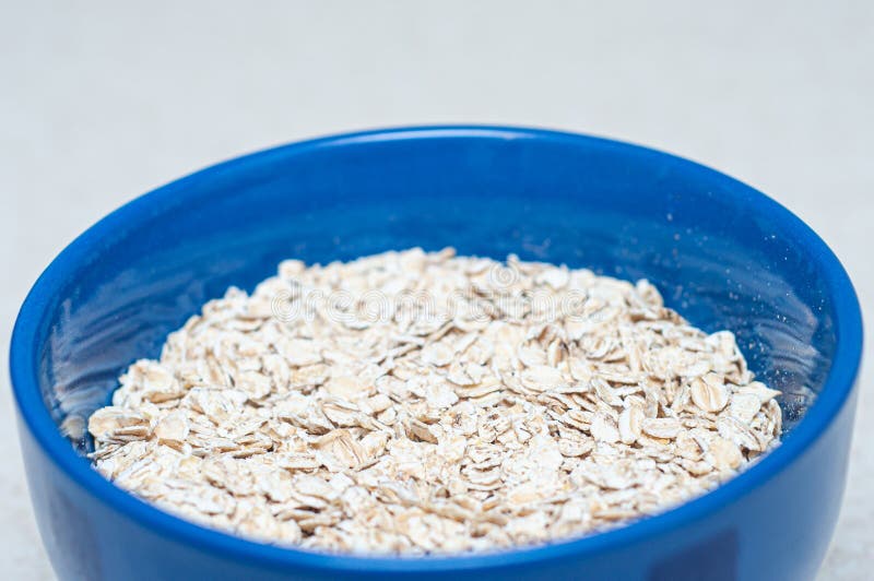 Oatmeal in a Blue Plate on a White Kitchen Table. Side View of an ...
