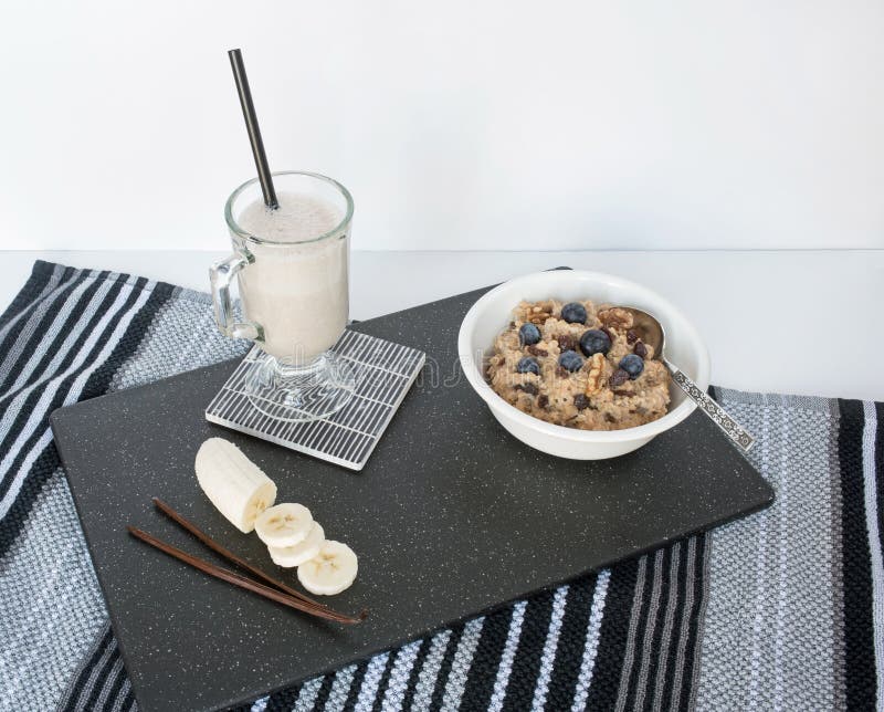 Oatmeal With Blueberries And Vanilla Banana Smoothie On Black Stock