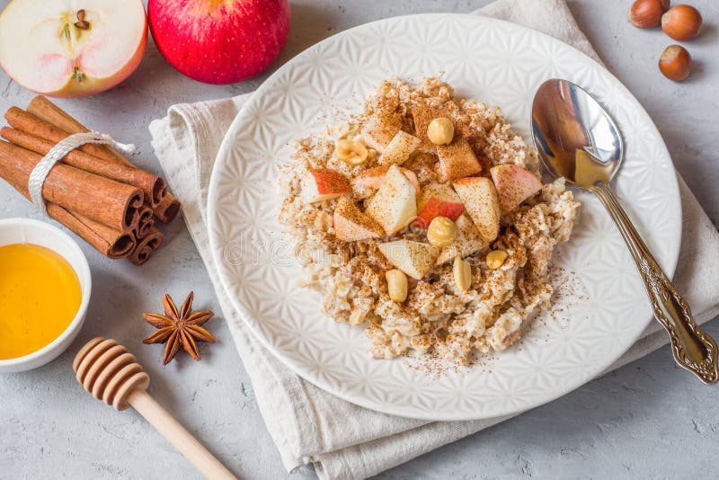 Oatmeal with Fresh Apples, Nuts and Cinnamon for Breakfast on Th Stock ...
