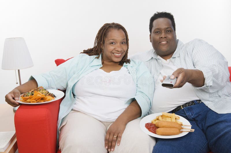 Obese Couple Sitting Together Stock Photo - Image of holding, indoors ...