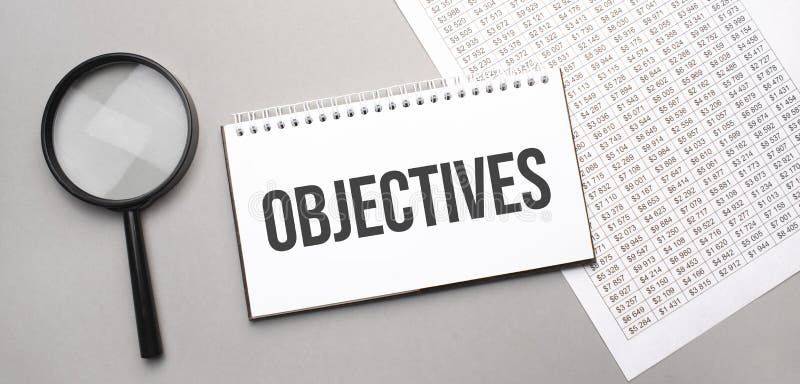 OBJECTIVES Sign in White Paper Notepad and Magnifying Glass on the Grey ...