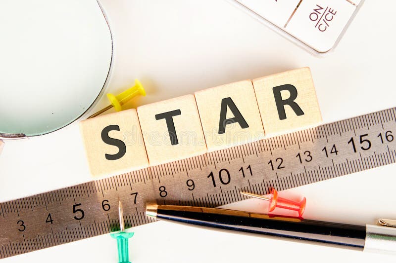 Objects on a Clean Workspace Include Wooden Blocks Spelling Out Star, a ...
