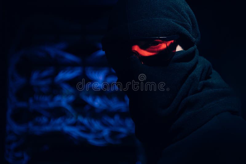 Obscured View of Hacker in Eyeglasses and Mask Looking at Camera with ...