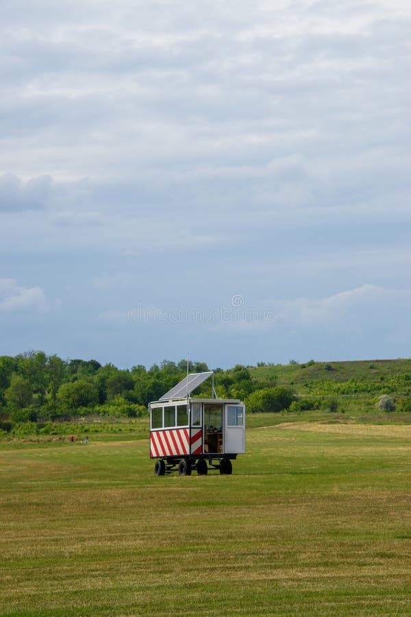 Observation Booth Working with Solar Panels in a Green Field Under ...