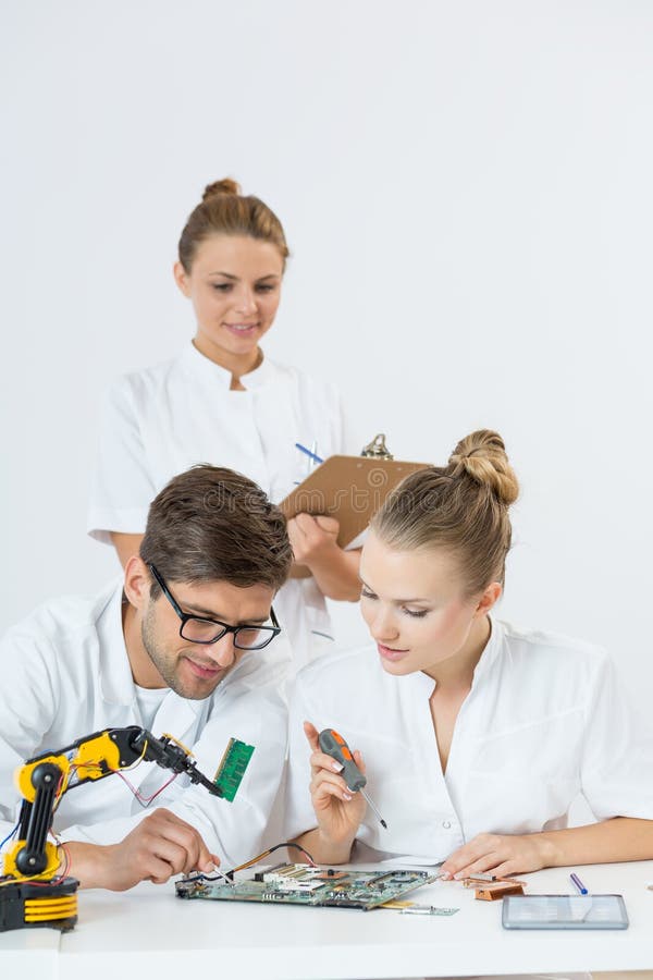 Observing Her Colleagues Work Stock Image - Image of technical, smiling ...