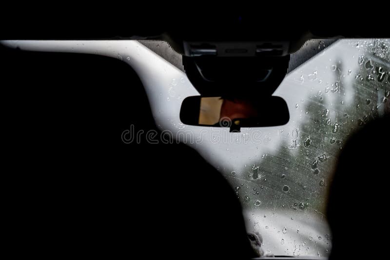 Obstructed View from the Back Seat of a Vehicle with Rain Falling on ...