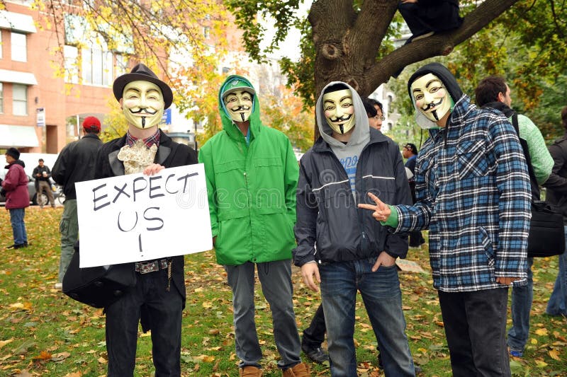 Two Protesters in Masks Hold Signs at Occupy L.a. Editorial Photo ...