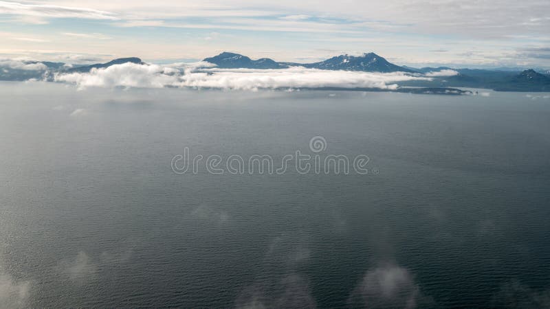 Ocean in Alaska with Distant Mountains and Clouds Stock Photo - Image ...
