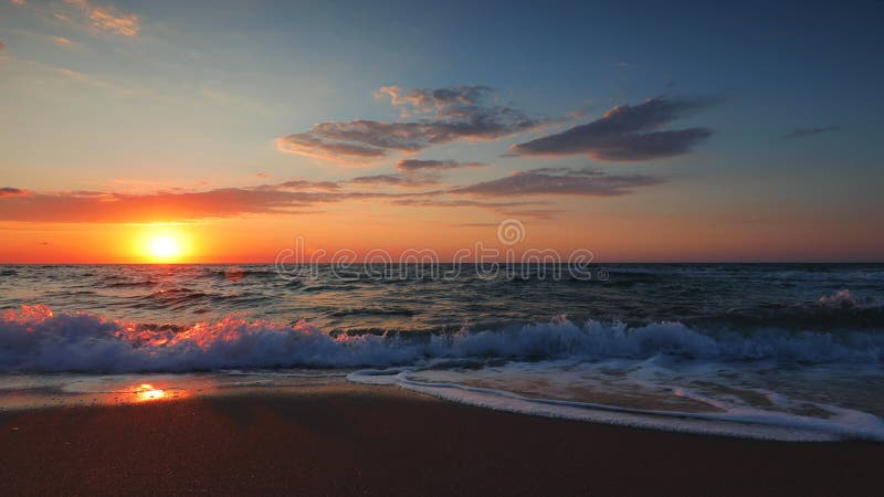 Ocean Beach Sunrise with Dark Sky Clouds and Sun Rays Over Sea Waves ...