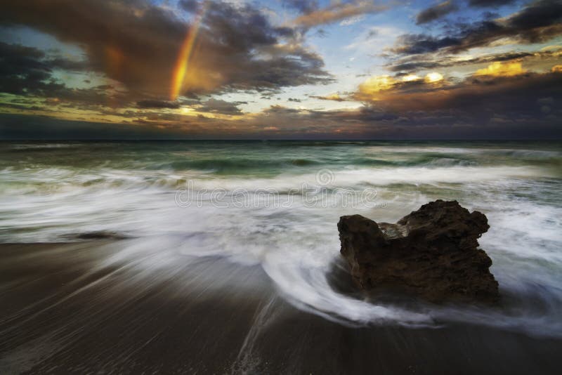 Ocean Beach with Waves, Rock, and Rainbow after Storm Stock Image ...