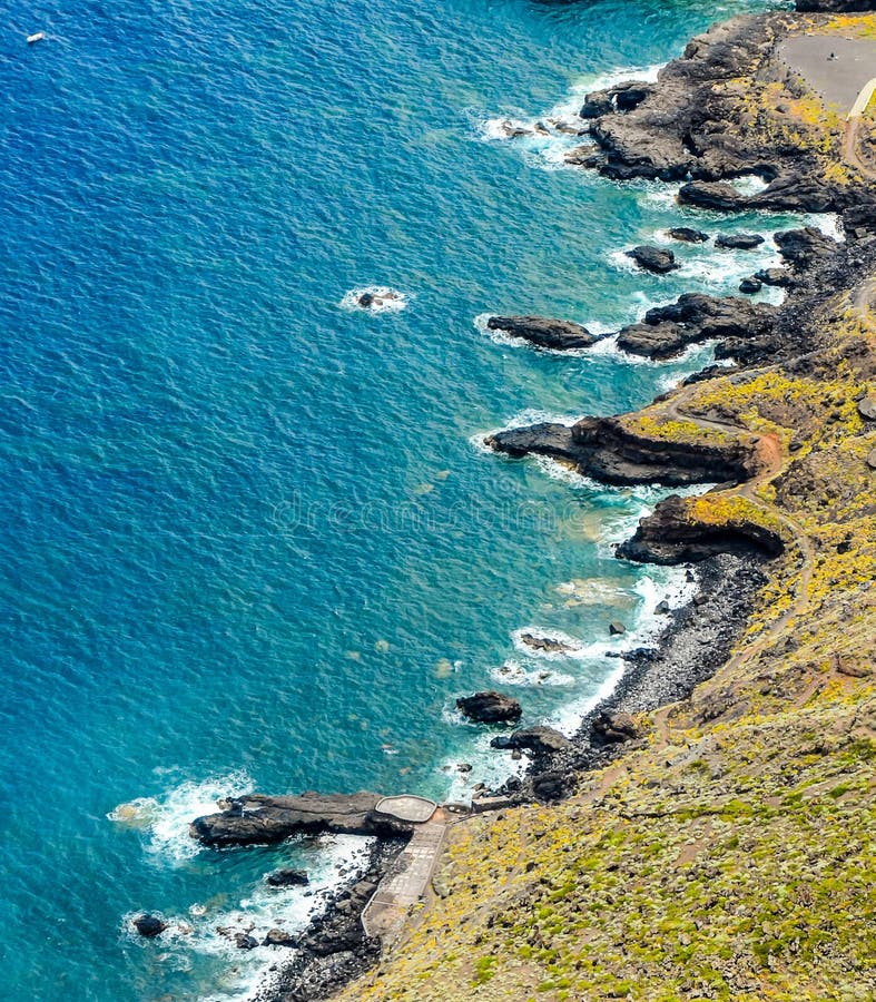The Ocean is Calm and the Rocks are Jutting Out of the Water Stock ...