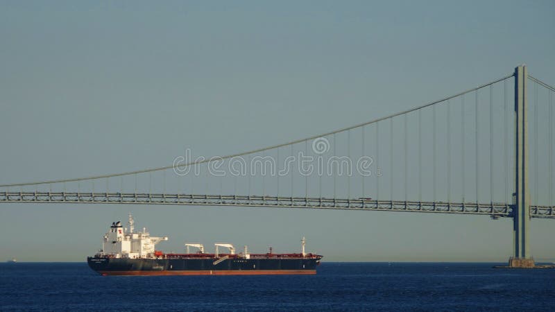 Ocean Cargo Ship and Suspension Bridge Editorial Photo - Image of water ...