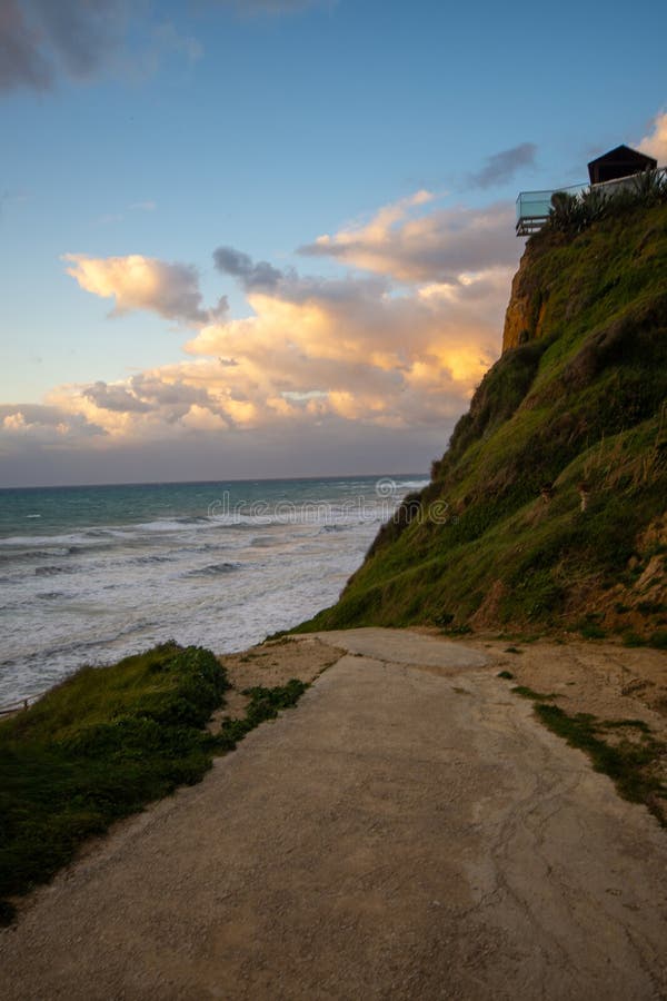Ocean Clifftop Path with Sunset Clouds and a Small Structure Stock ...