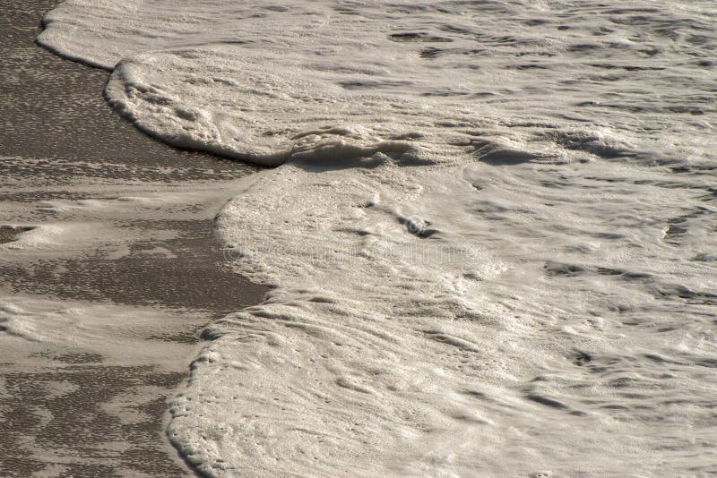 Ocean Foam from Waves in the Beach Sand Stock Photo - Image of waves ...