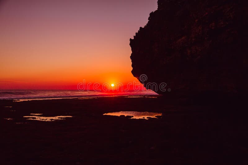 Ocean with Rock and Bright Sunset or Sunrise in Bali Stock Photo ...