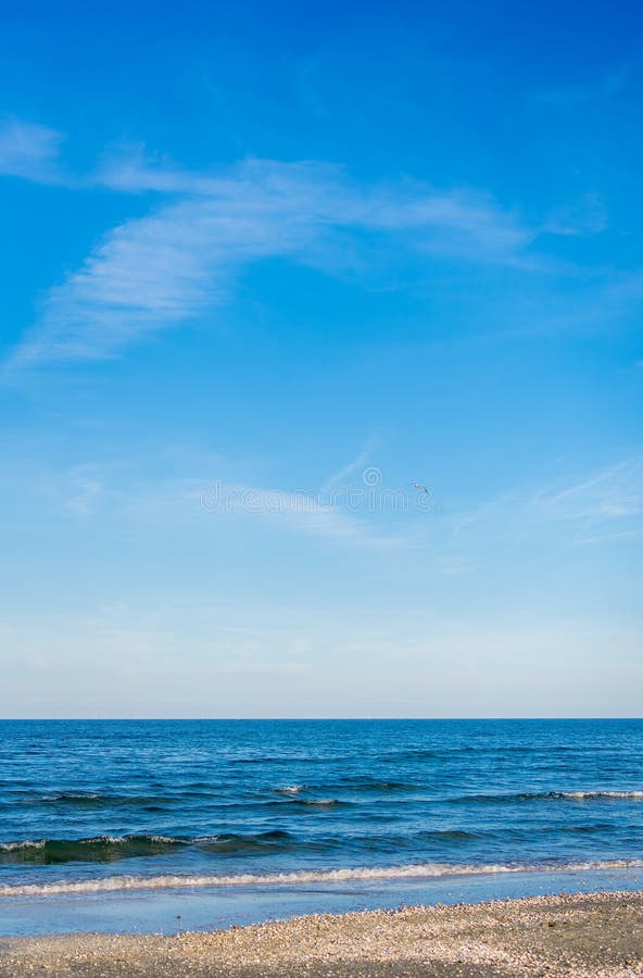 The Ocean and Sky is Blue with Some Clouds Above it Stock Image - Image ...