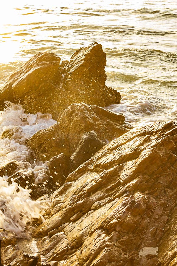 Ocean Splash on Sharp Boulders with Light Reflection Stock Image ...