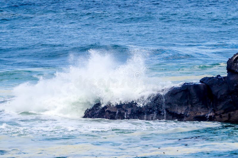 Ocean splashing over rocks stock image. Image of serenity - 76519377