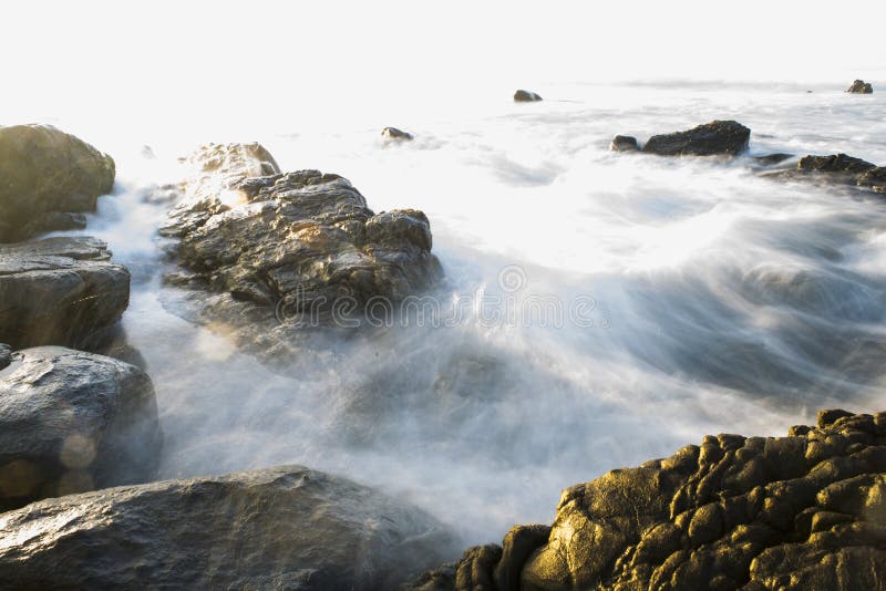 Ocean Tide Flowing Over Rocks Stock Photo - Image of setting, rocks ...