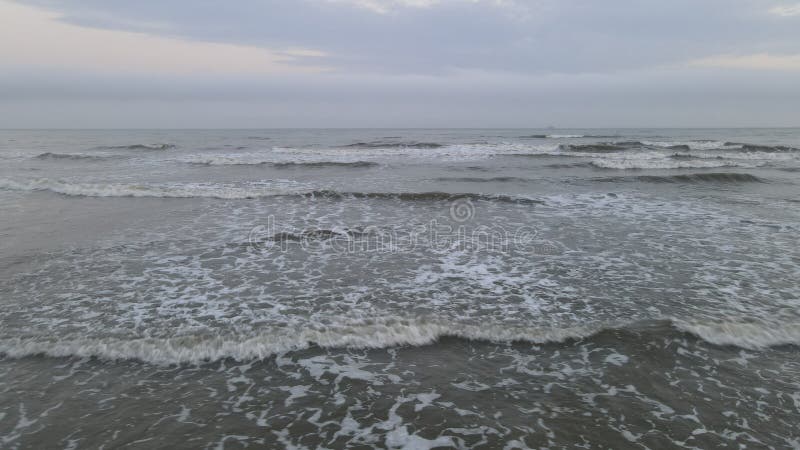 Ocean Tide Meets Sandy Beach Under Gathering Clouds Stock Photo - Image ...