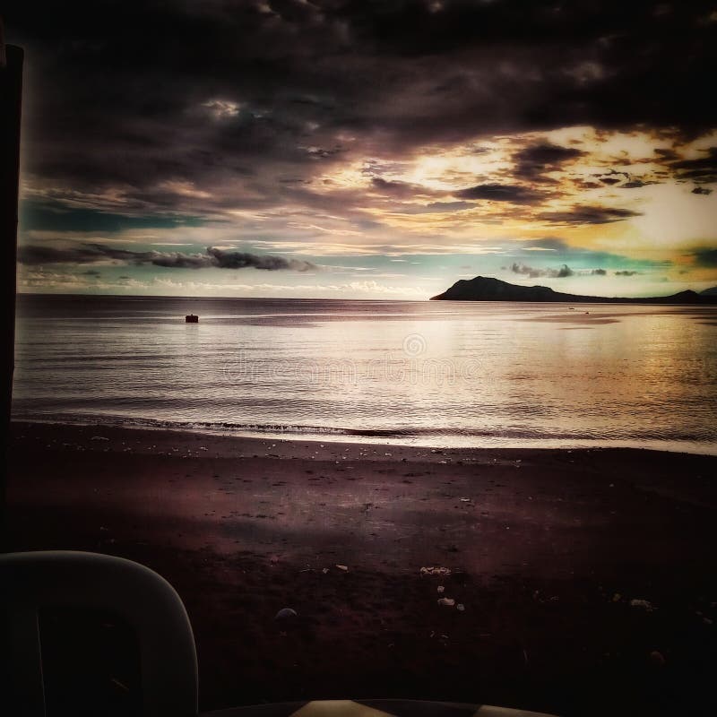 The ocean view at sunset stock photo. Image of evening - 204385278