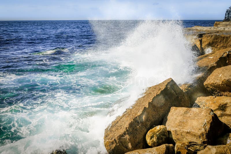 Wave breaking on the rocks stock image. Image of tide - 51117335
