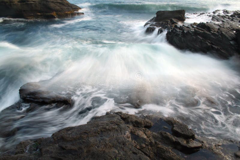 Ocean Wave Crashing Over Multiple Rock Outcrops Stock Photo - Image of ...