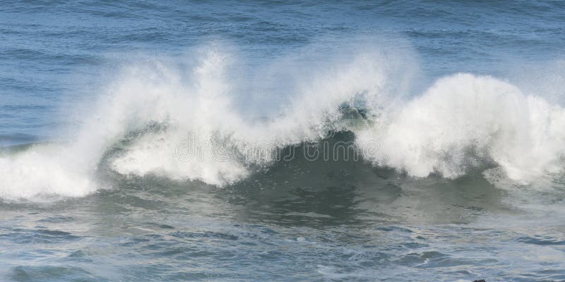 Ocean Wave Crashing in a State of Confusion Against Blue Water Stock ...
