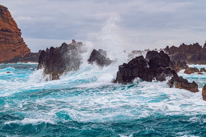 Ocean Waves Break Against Coastal Cliffs on a Cloudy Summer Day Stock ...