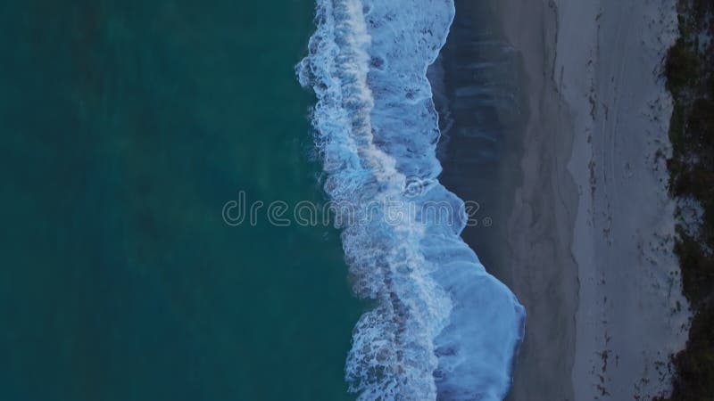 Sea Waves Crash on the Coast at Night at Blue Hour Overhead Vertical ...