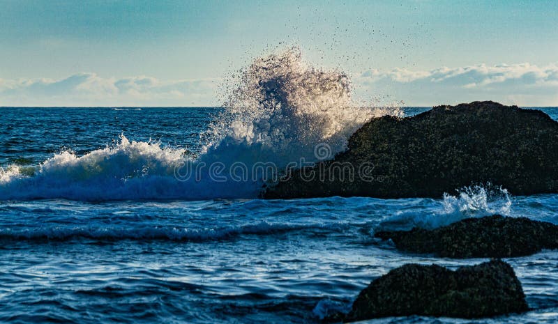 Ocean Waves Crashing into the Big Rocks on Cannon Beach, Oregon Stock ...