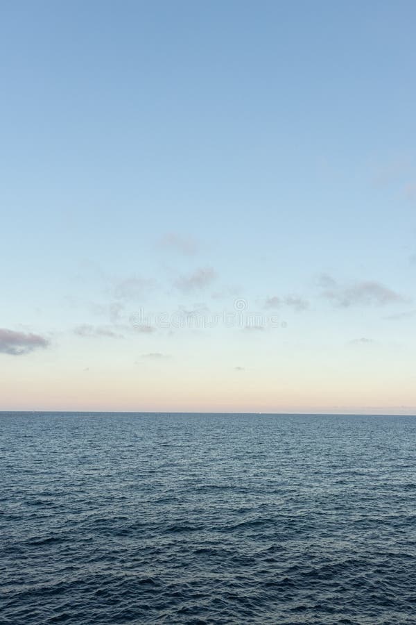 Ocean Waves Gleaming Under the Beautiful Pink and Blue Sky Stock Photo ...