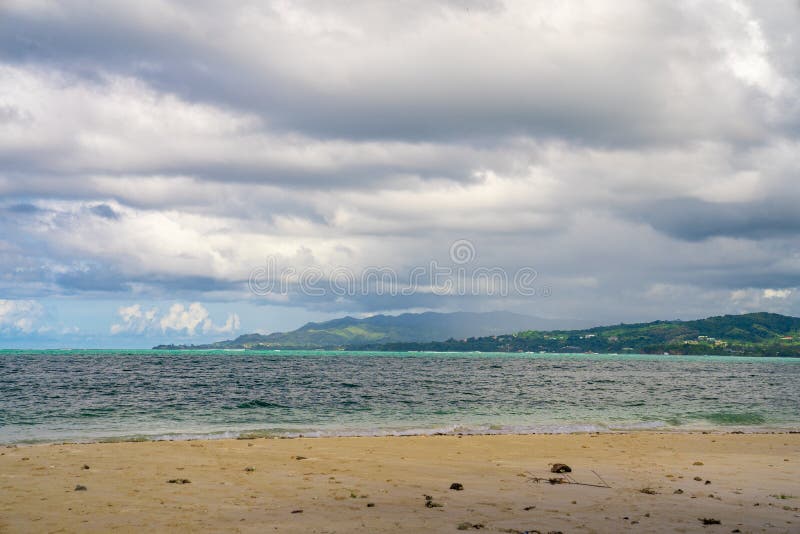 Ocean Waves Hitting the Sandy Beach and Gleaming Under the Cloudy Sky ...